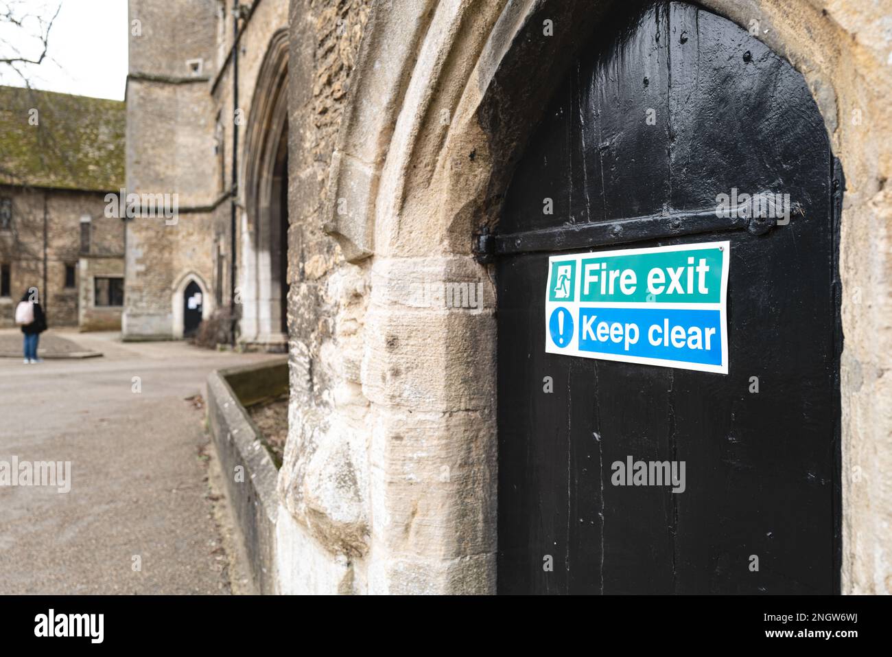 Shallow focus of a Fire Exit sign seen attached to a medieval, wooden ...