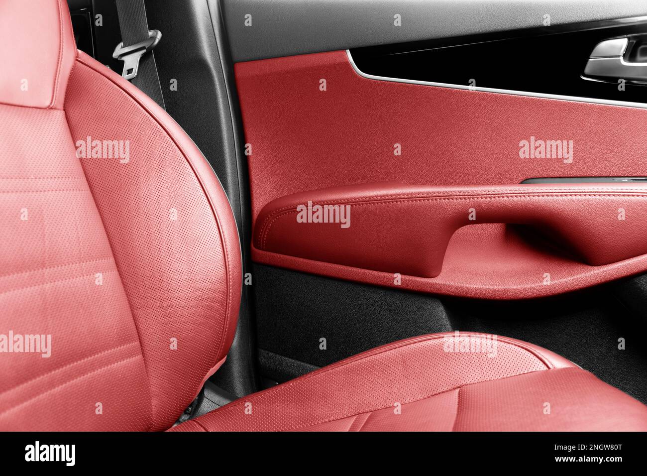 Modern luxury car red leather interior. Part of red perforated leather ...