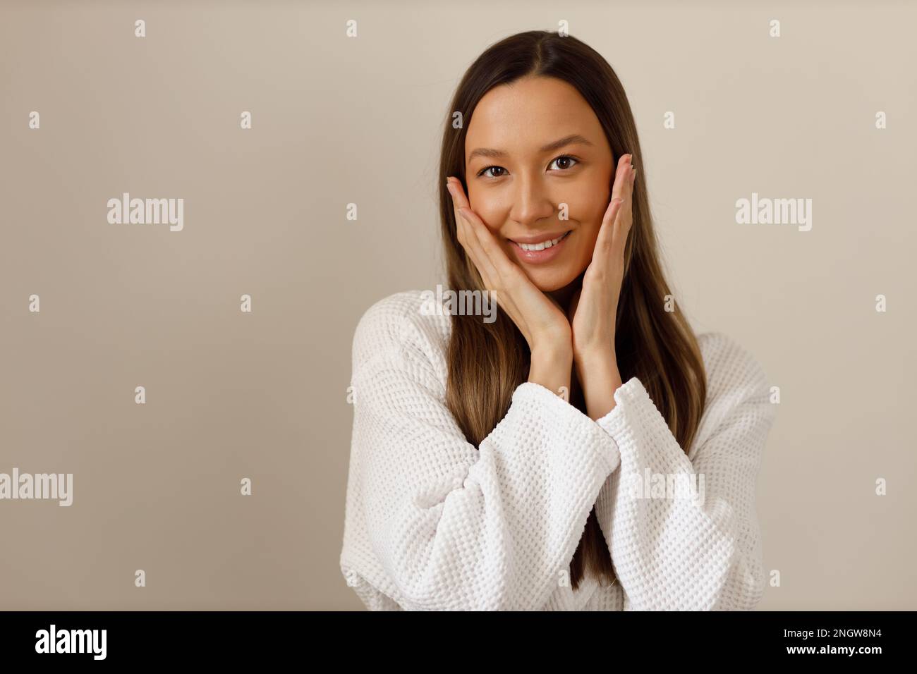 Young smiling multiracial woman doing face building yoga and facial ...