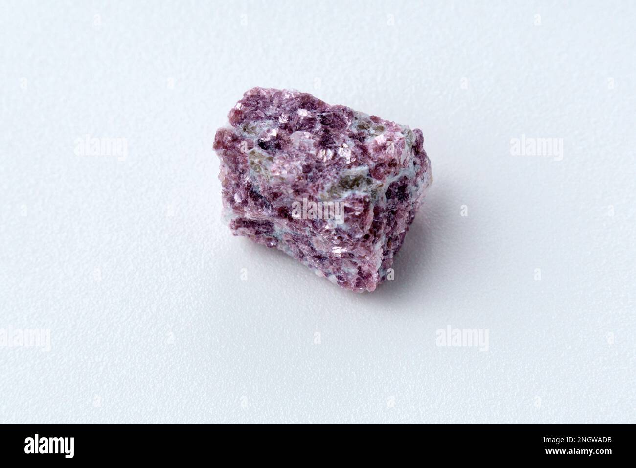Lepidolite stone on a white background, being a secondary source of ...