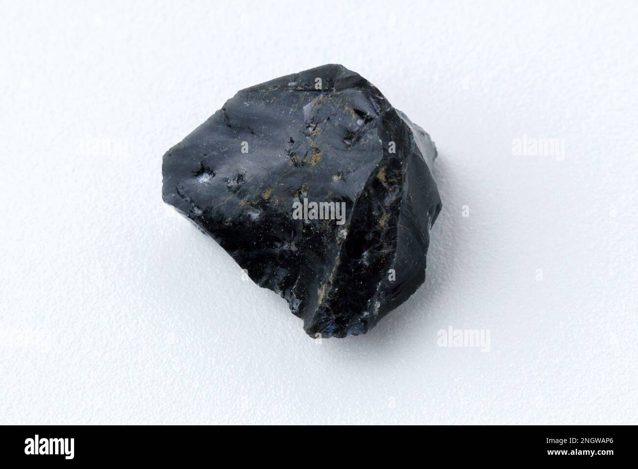 Obsidian rock. Volcanic material. Rough edges. Sharpest rock white ...