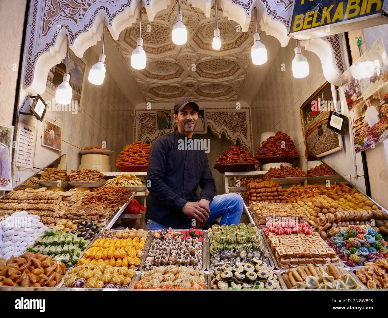 Vendor selling assorted Moroccan sweets and cookies in food stall in ...