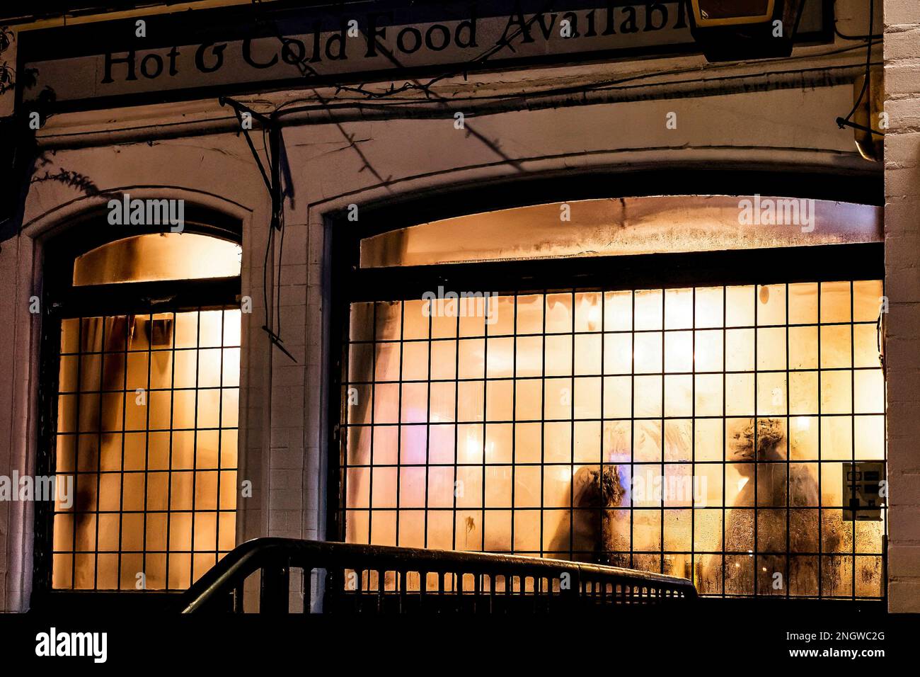 Blurred silhouette of a couple in conversation behind a steamy pub window. Intriguing. Shadow ...