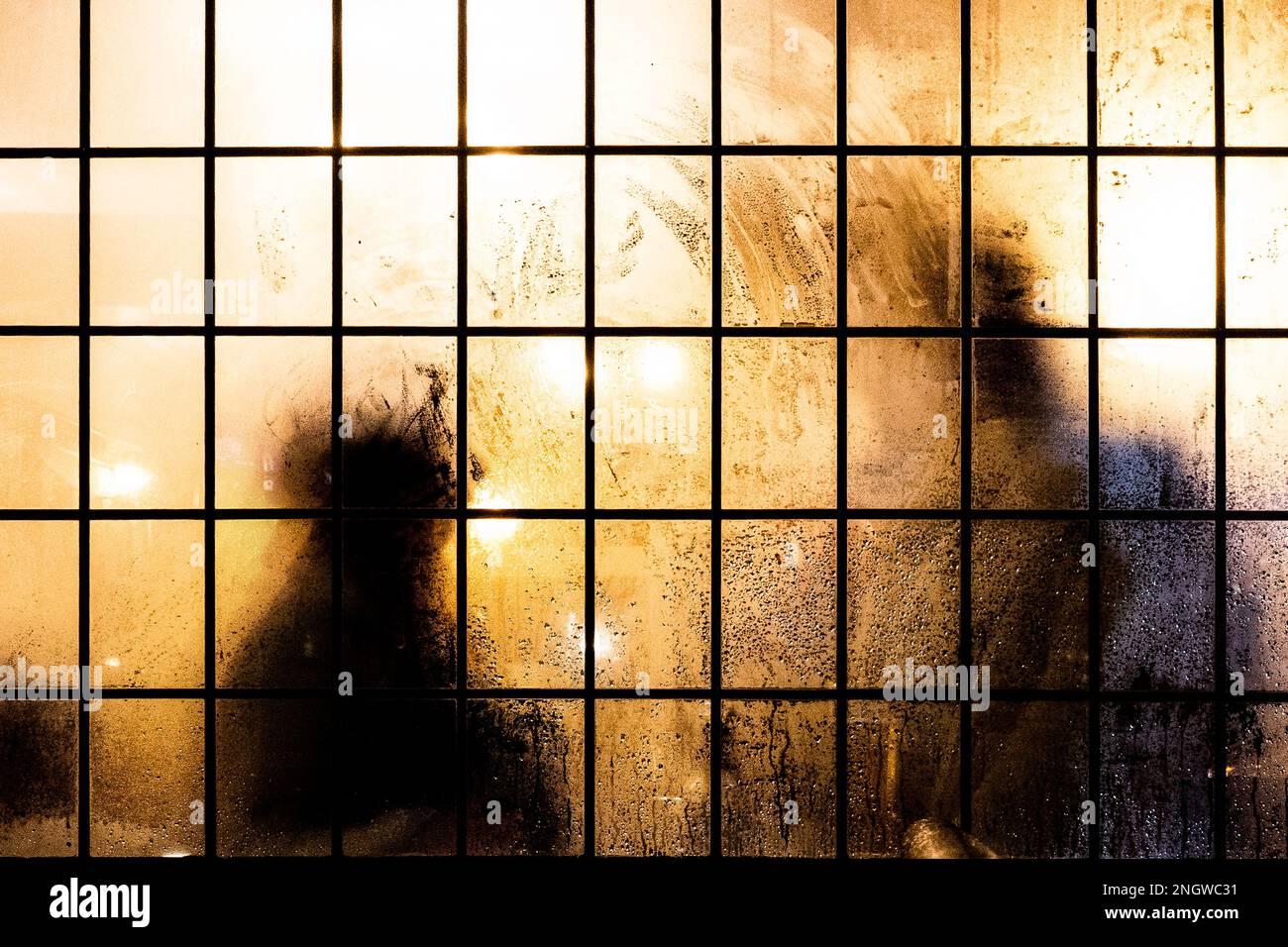 Blurred silhouette of a couple in conversation behind a steamy pub window. Intriguing. Shadow ...