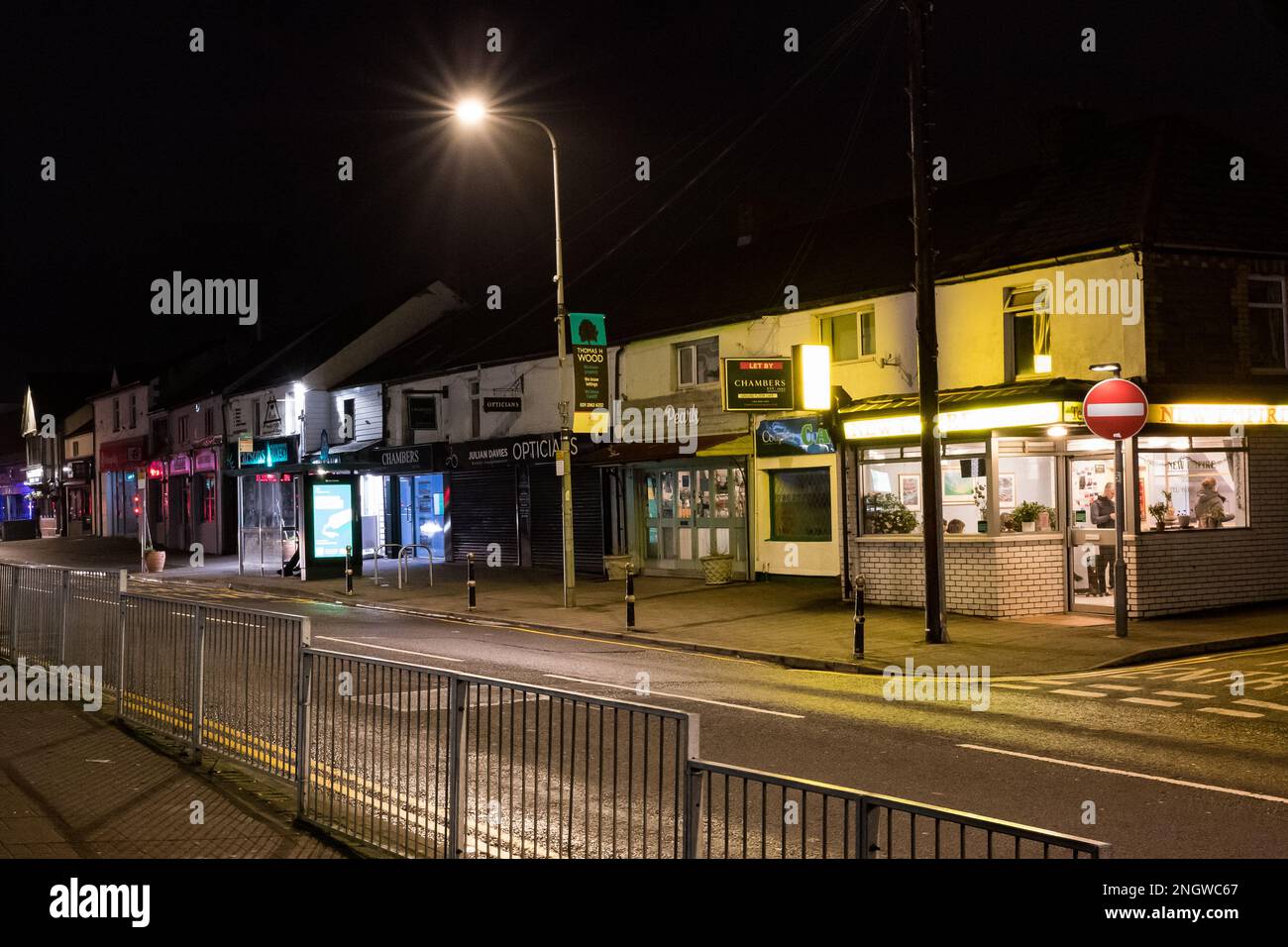 Chinese takeaway at night in a suburban high street with customers ...