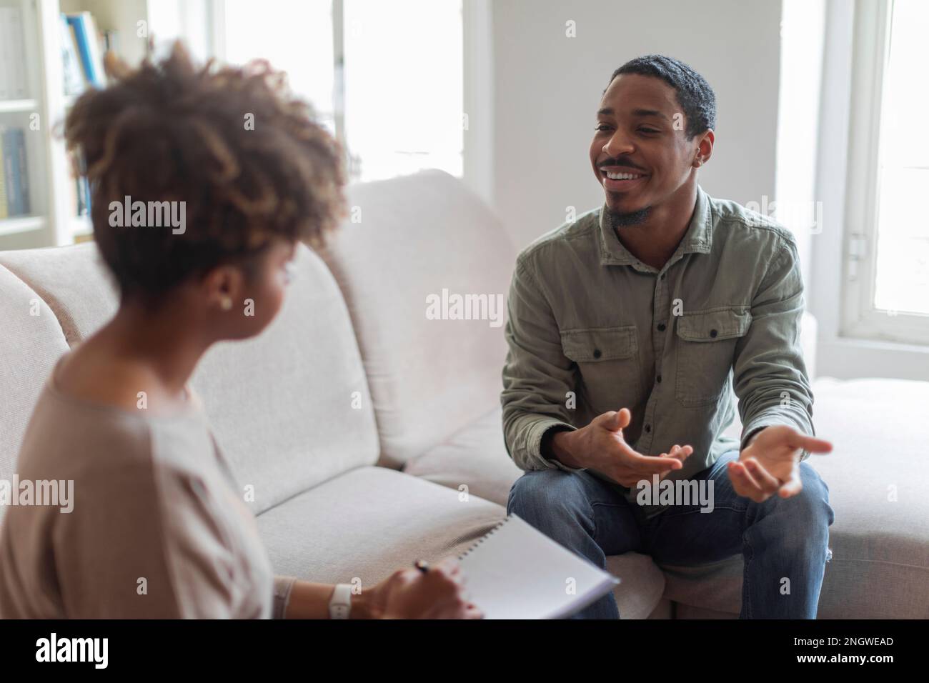 Cheerful positive african american guy having conversation with ...