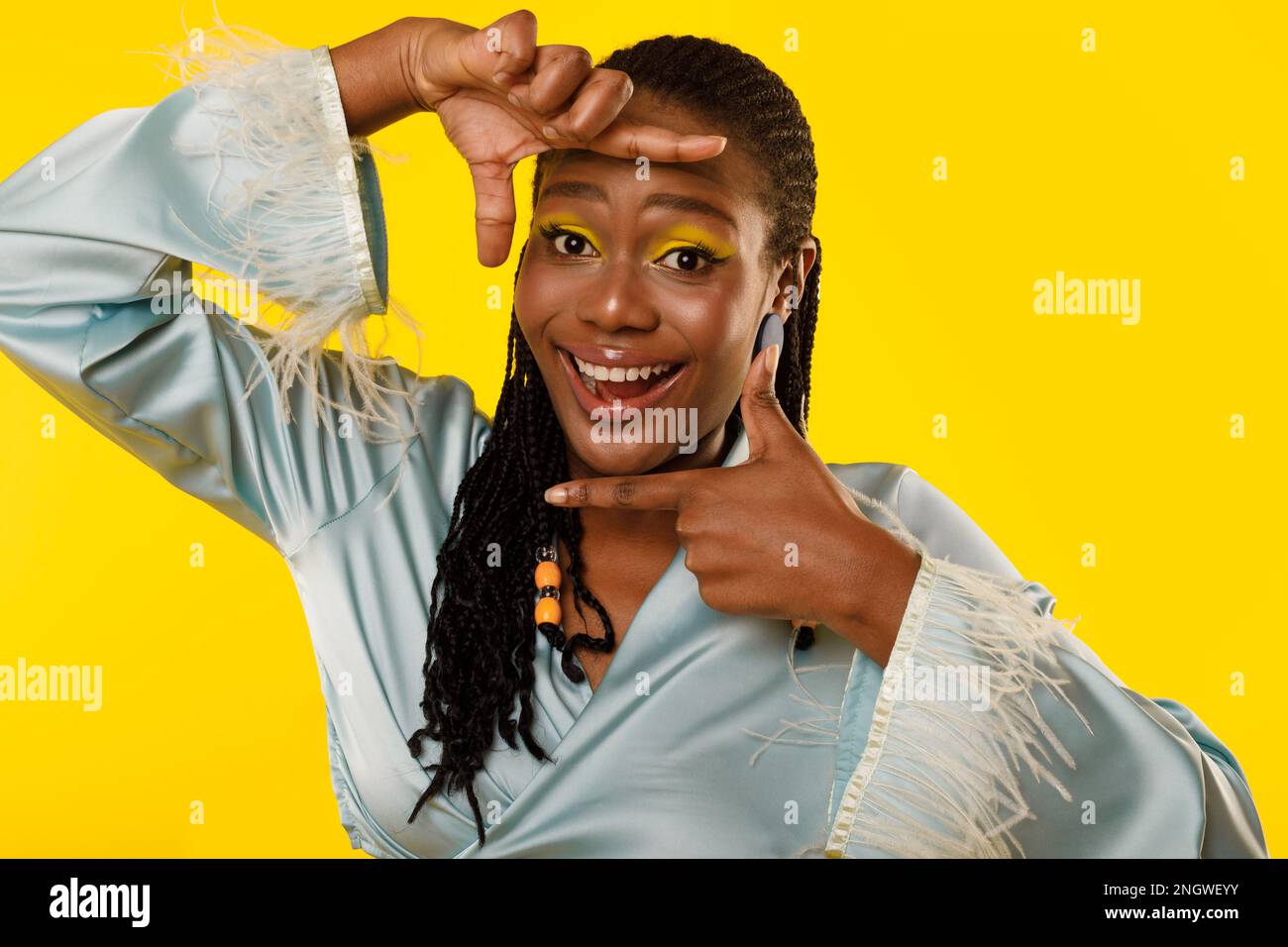 Pretty Black Lady Framing Face With Fingers Over Yellow Background ...