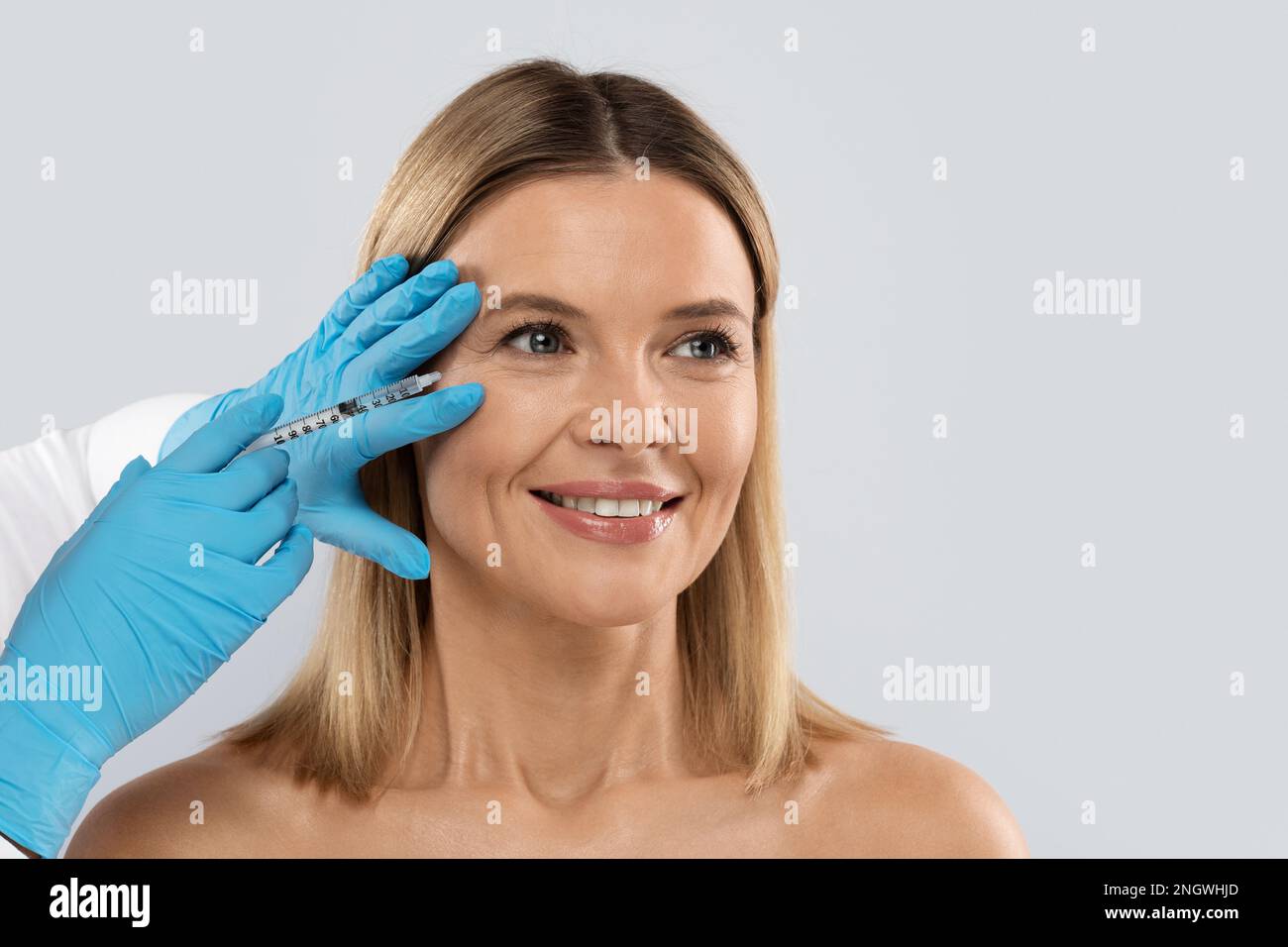 Middle aged woman gets cosmetic eye injection Stock Photo - Alamy