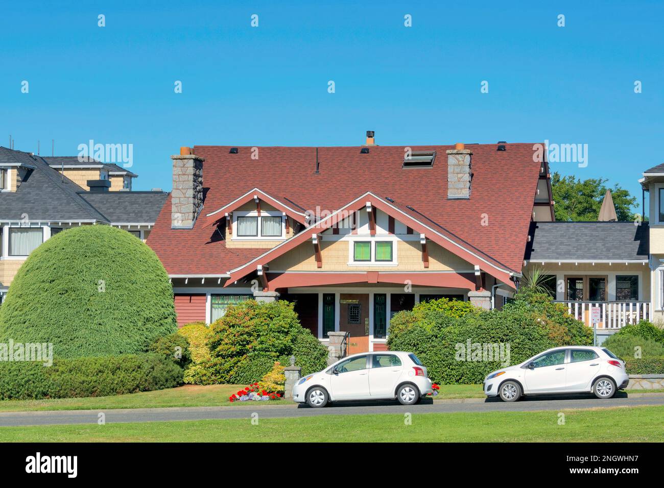 Luxury residential house with two small cars parked in front Stock ...