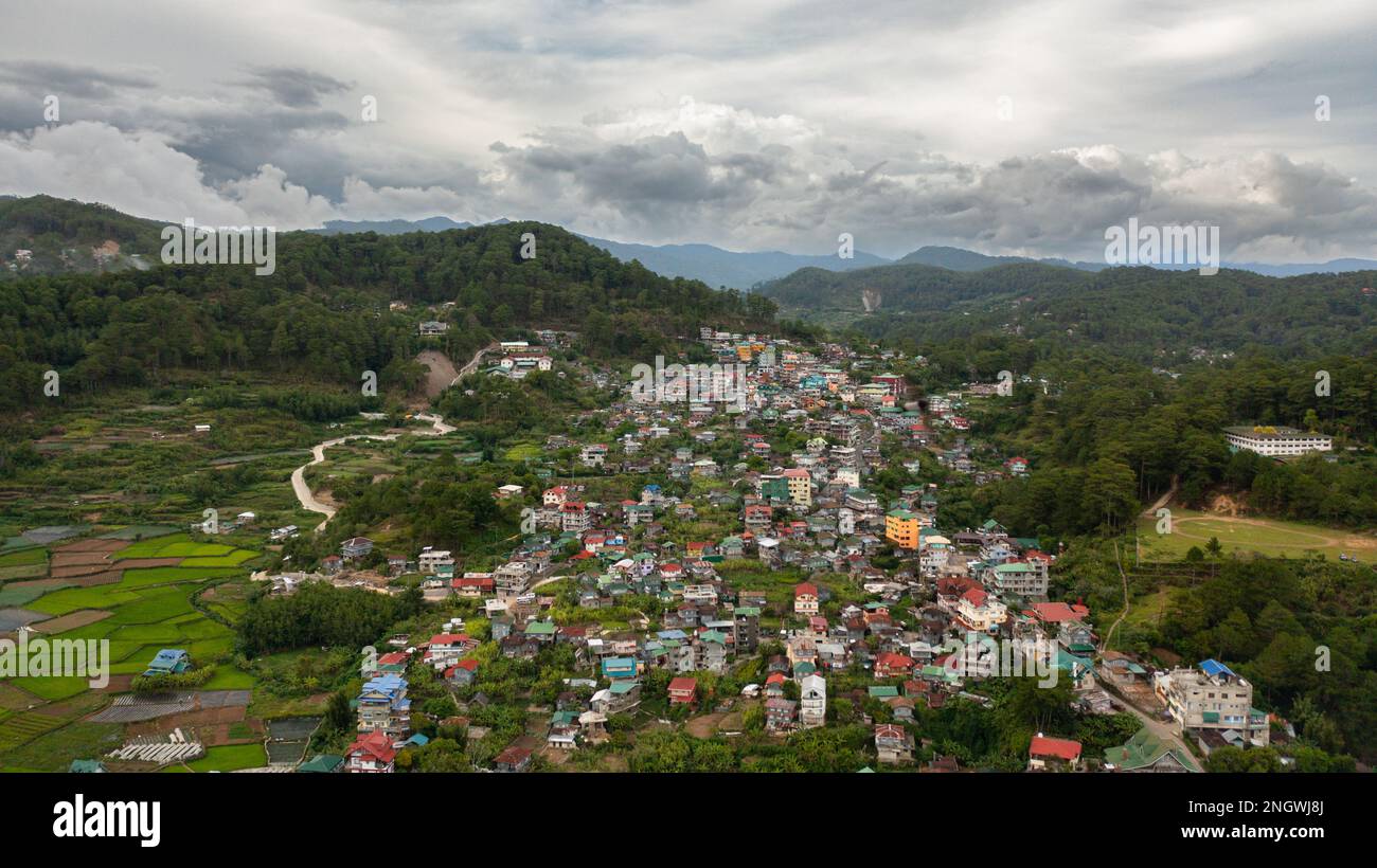 Town of Sagada in the valley among the mountains covered with forest ...