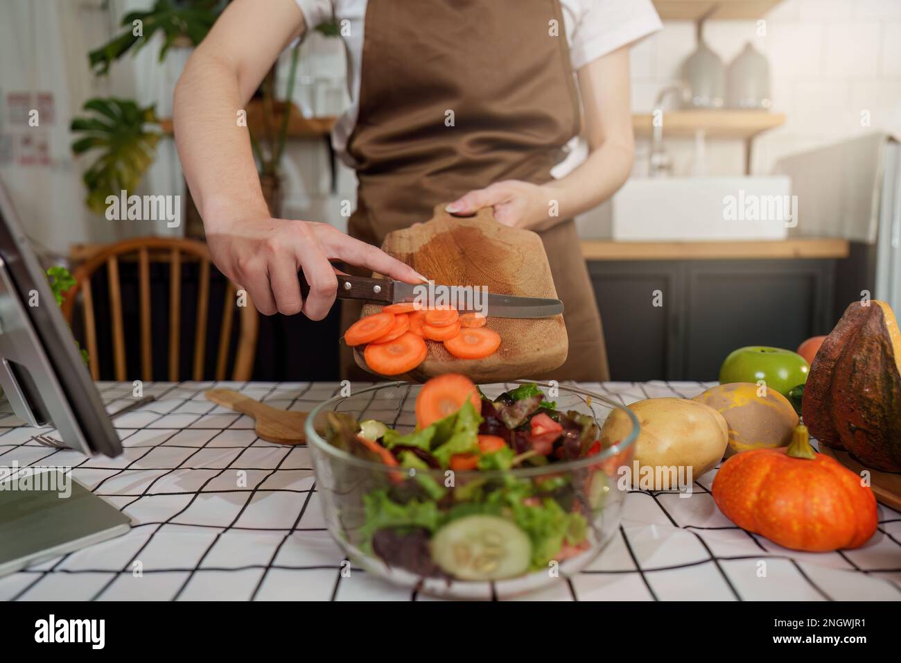 Young Healthy woman cooking healthy food in the kitchen at home ...