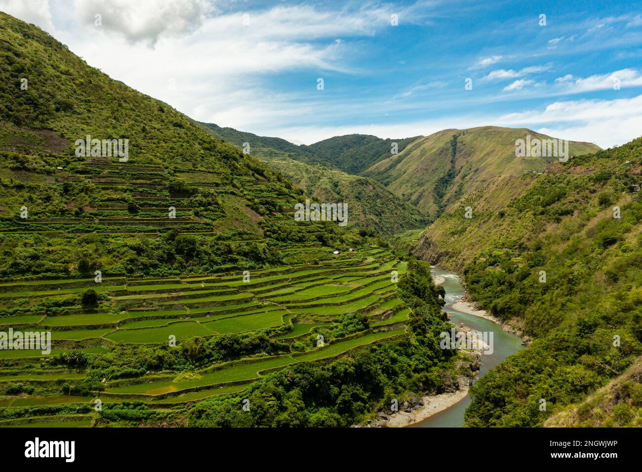 Aerial view of mountains and rice fields against the blue sky ...
