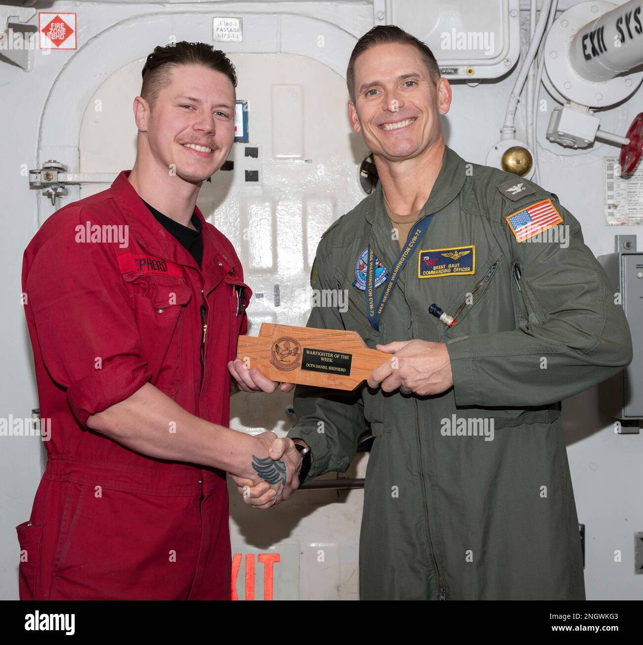 Capt. Brent C. Gaut, right, from Stockton, California, commanding officer of the Nimitz-class ...