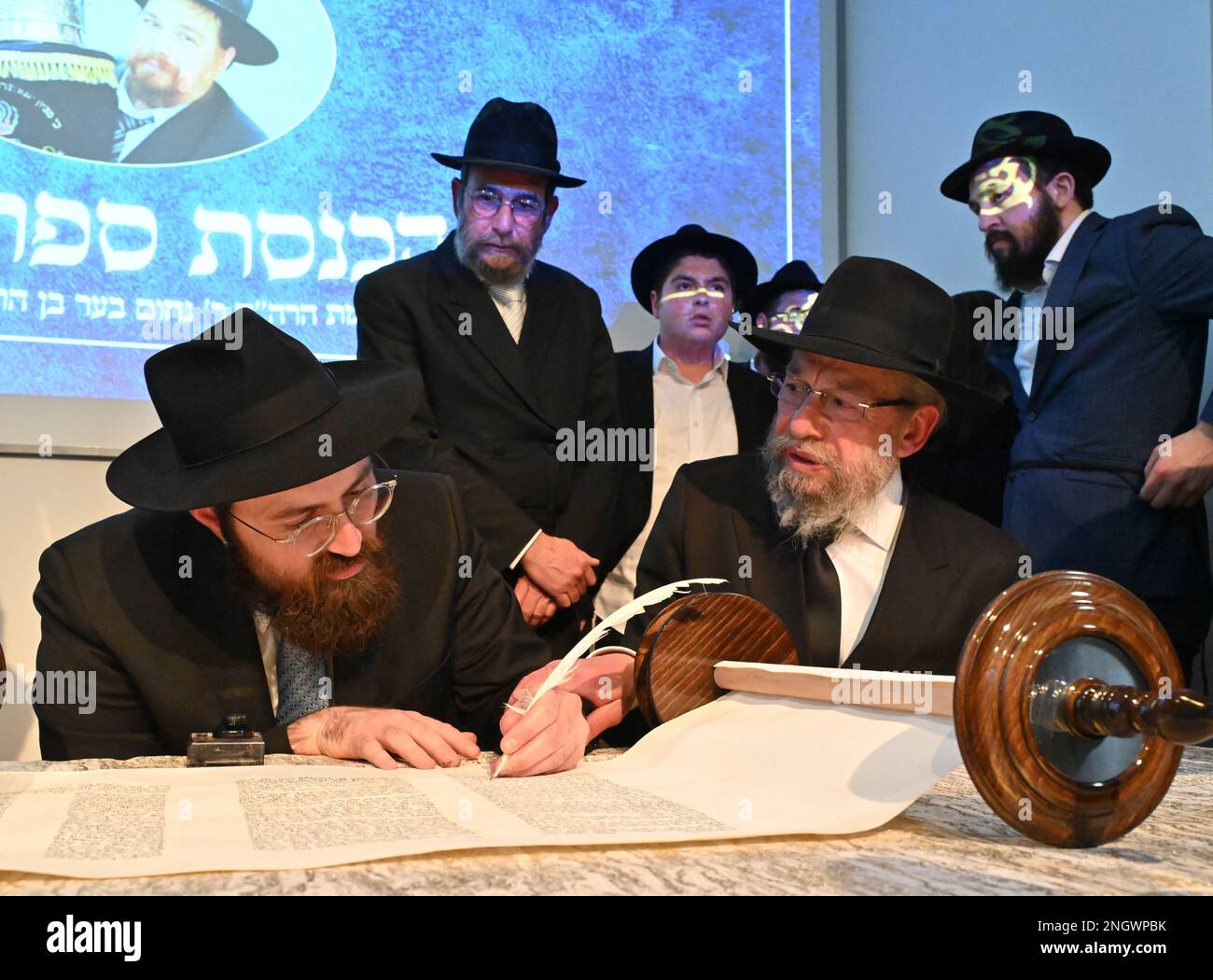 Potsdam, Germany. 19th Feb, 2023. Rabbis write the last letters on the ...