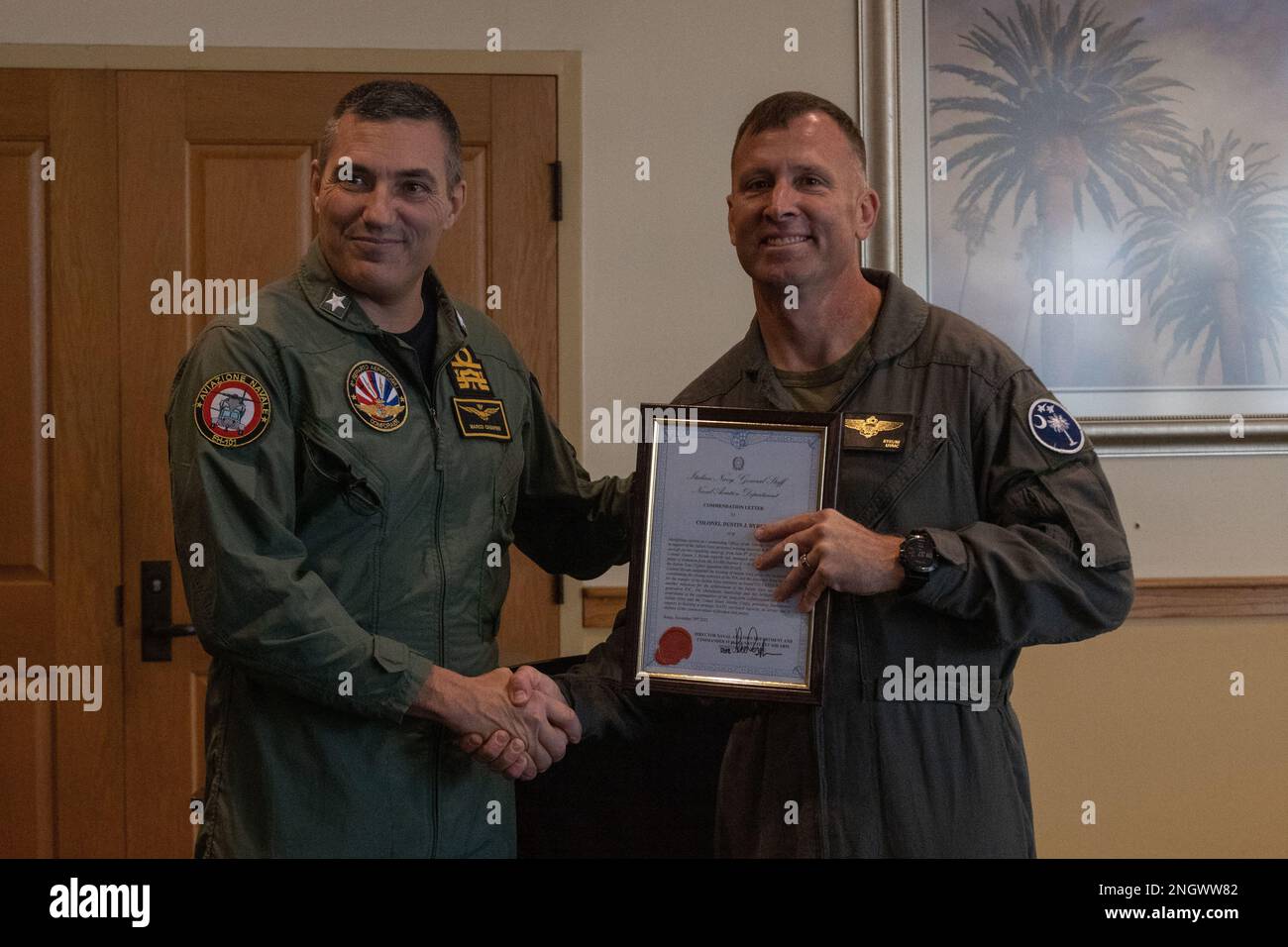 Italian Navy Rear Adm. Marco Casapieri, chief of naval air forces, presents an award to U.S ...