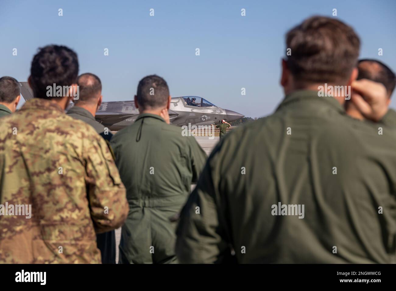 U.S. Marines and Italian F-35B pilots and maintainers watch a F-35B ...