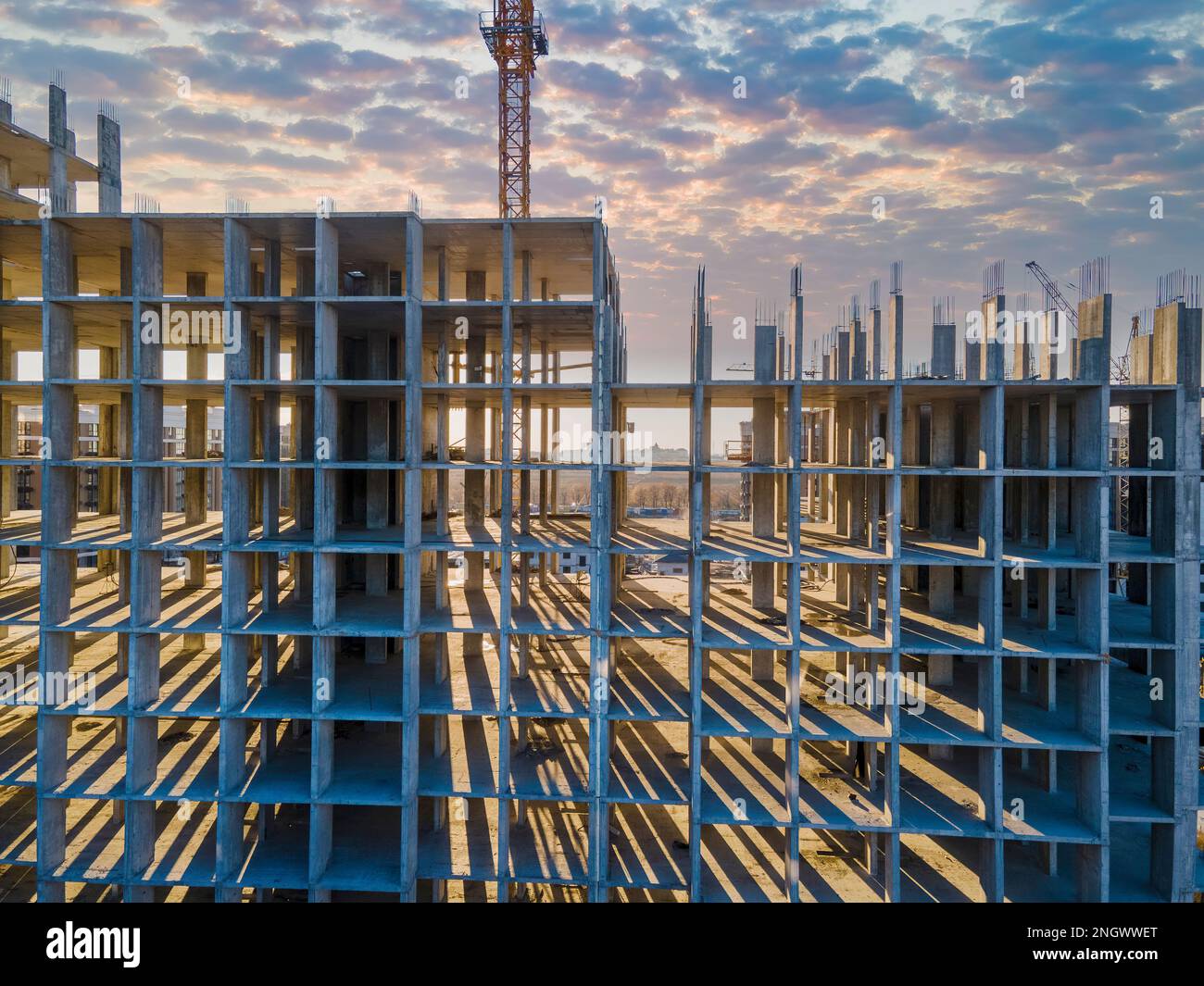 Building under construction with sunset sun shining through the ...
