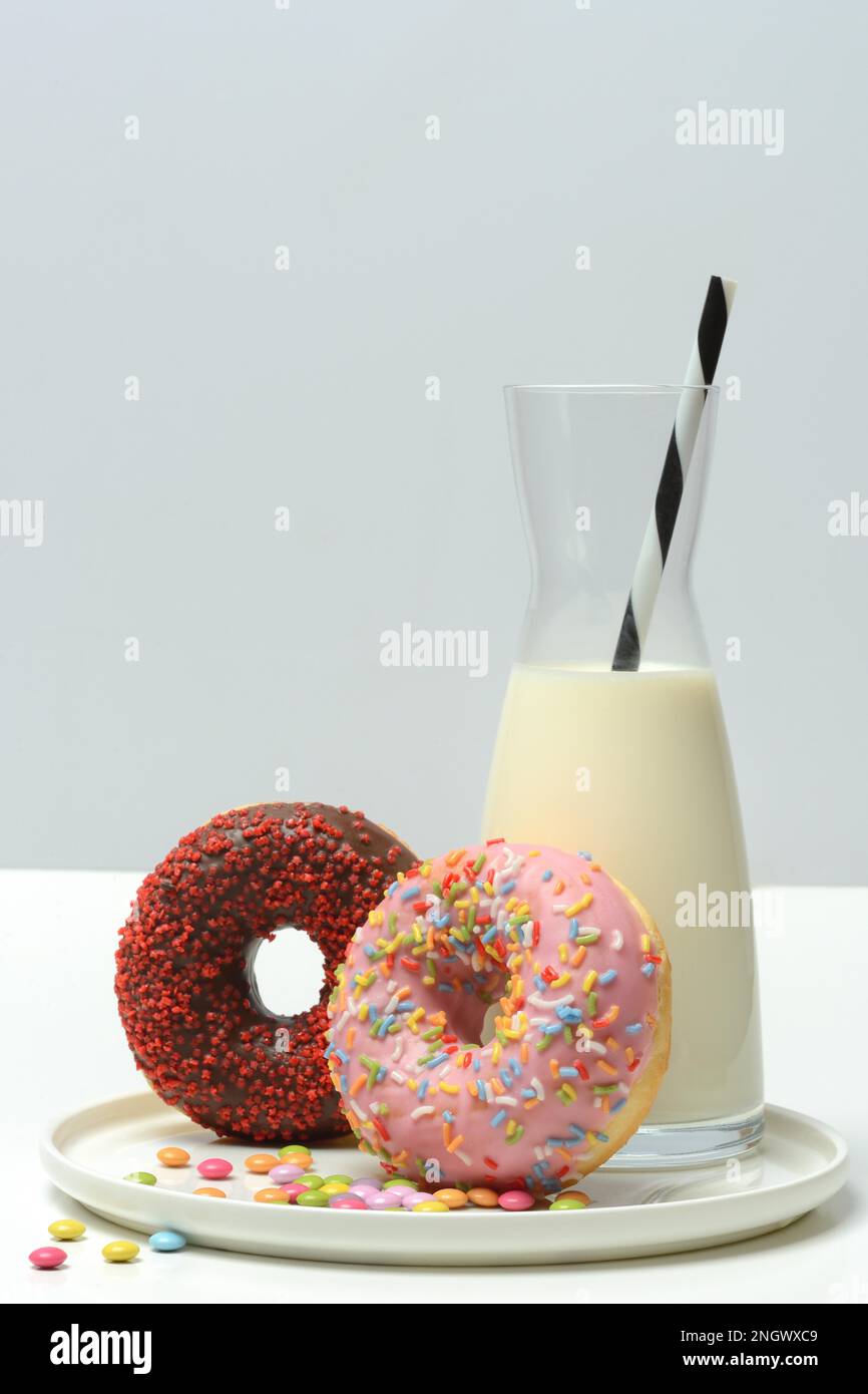 Assorted donuts and jar with milk Stock Photo - Alamy