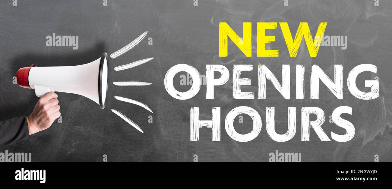 hand holding red and white megaphone against chalkboard with text NEW OPENING HOURS Stock Photo ...