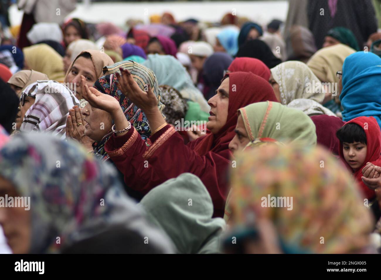 Muslim women raise their hands in prayers as the head cleric (unseen ...