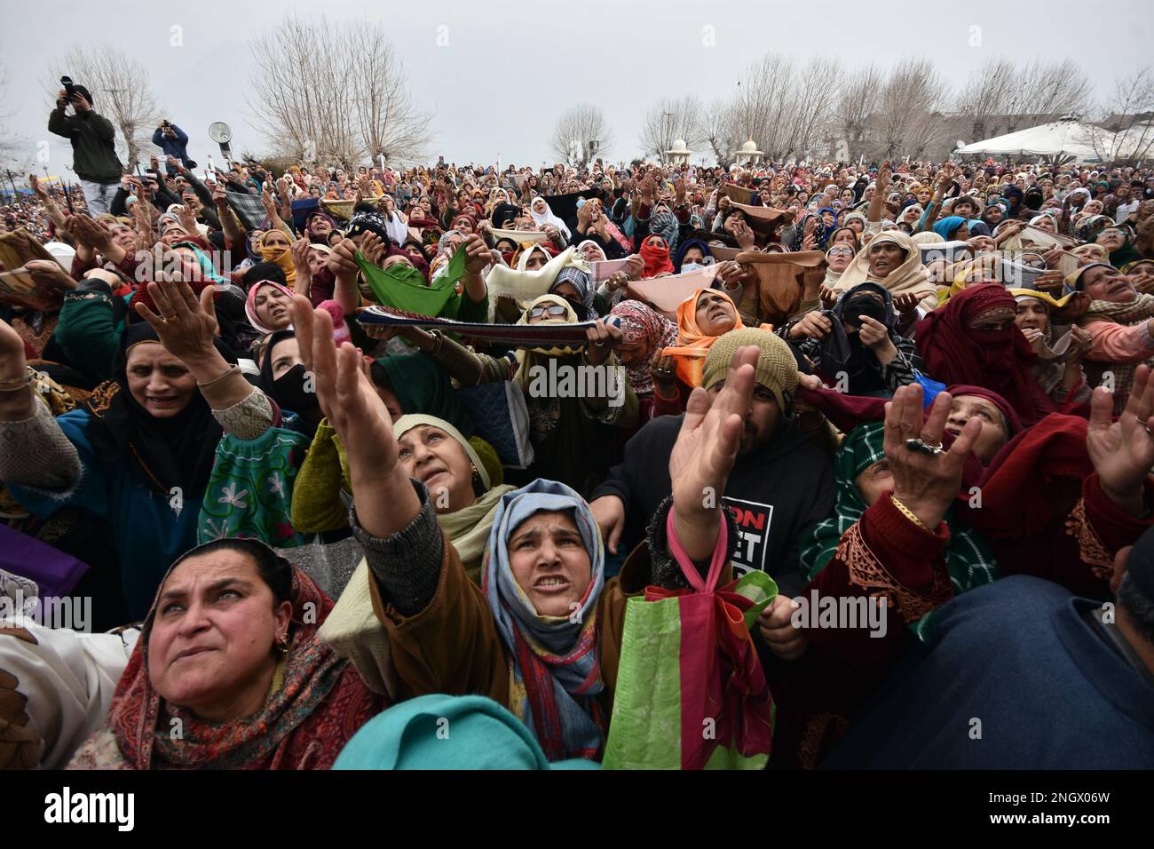 Muslim women raise their hands in prayers as the head cleric (unseen ...