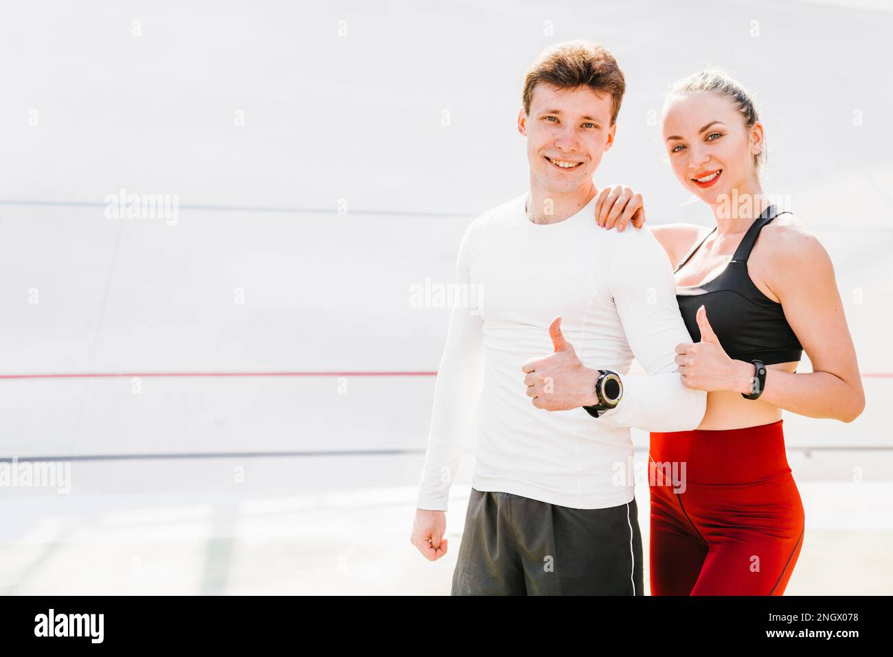 medium shot sporty couple approving Stock Photo - Alamy