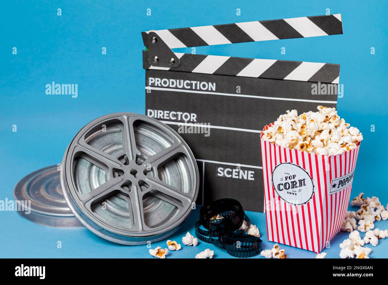 film reels film strips clapperboard with popcorn box blue background ...
