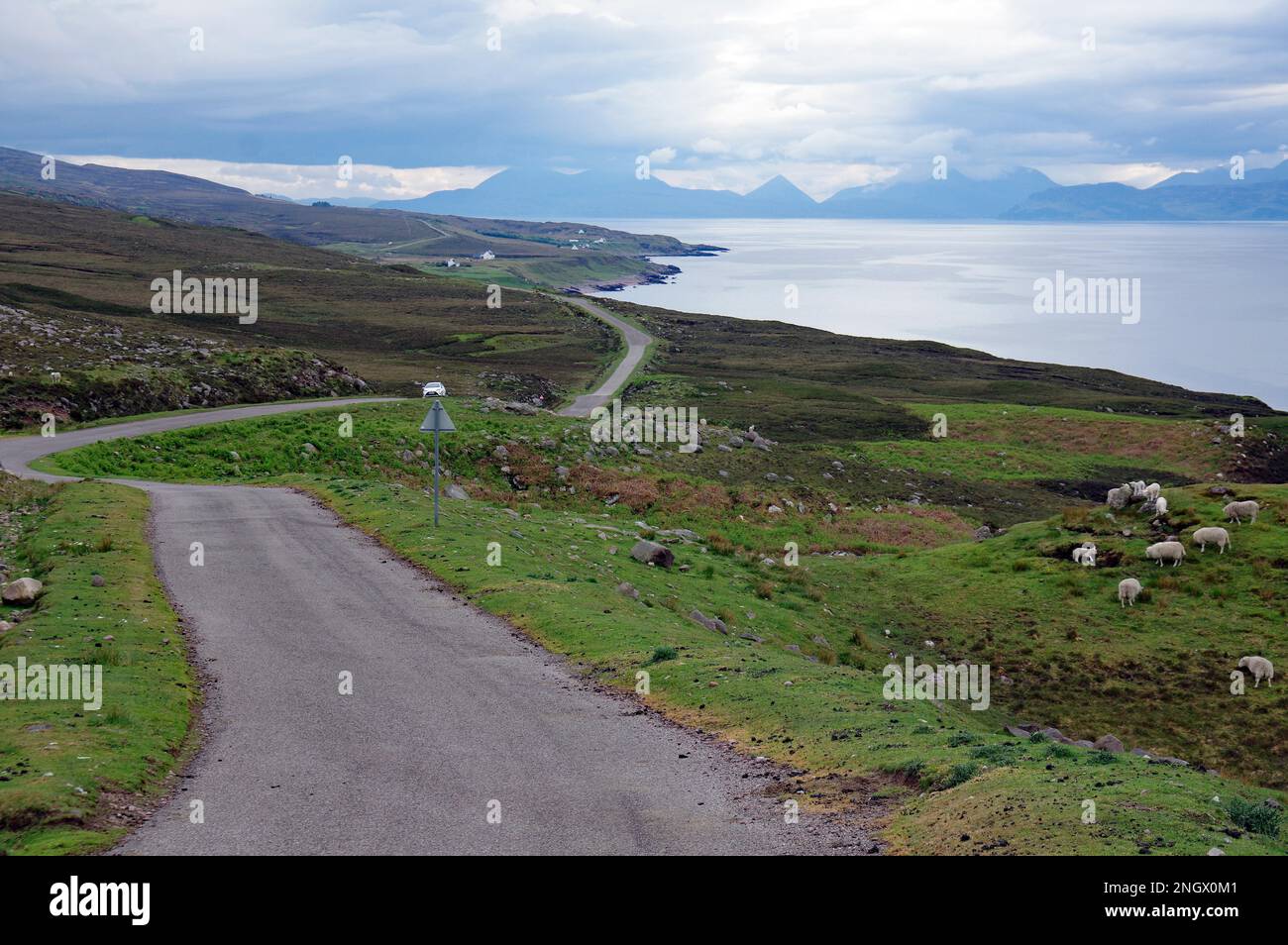 Narrow, single-track road, winds through wide, green landscapes along ...