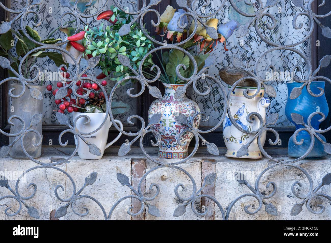 Pots and ornate bars on window in Tuscany Stock Photo - Alamy