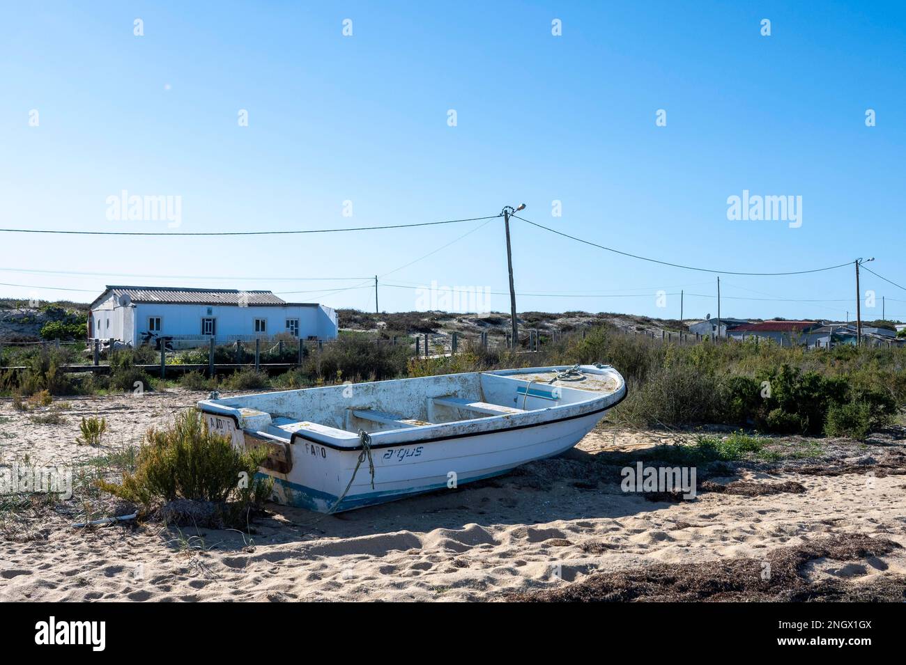 Fishing boat on the beach of the Ria Formosa nature park Park, Faro ...