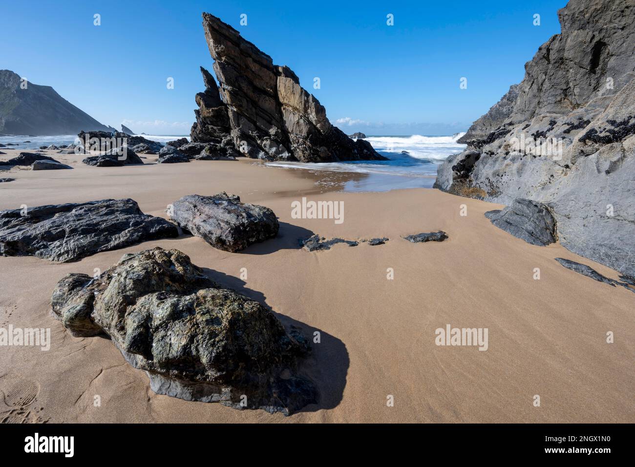Rocky coast and sandy beach at Praia da Adraga, Colares, Portugal Stock ...