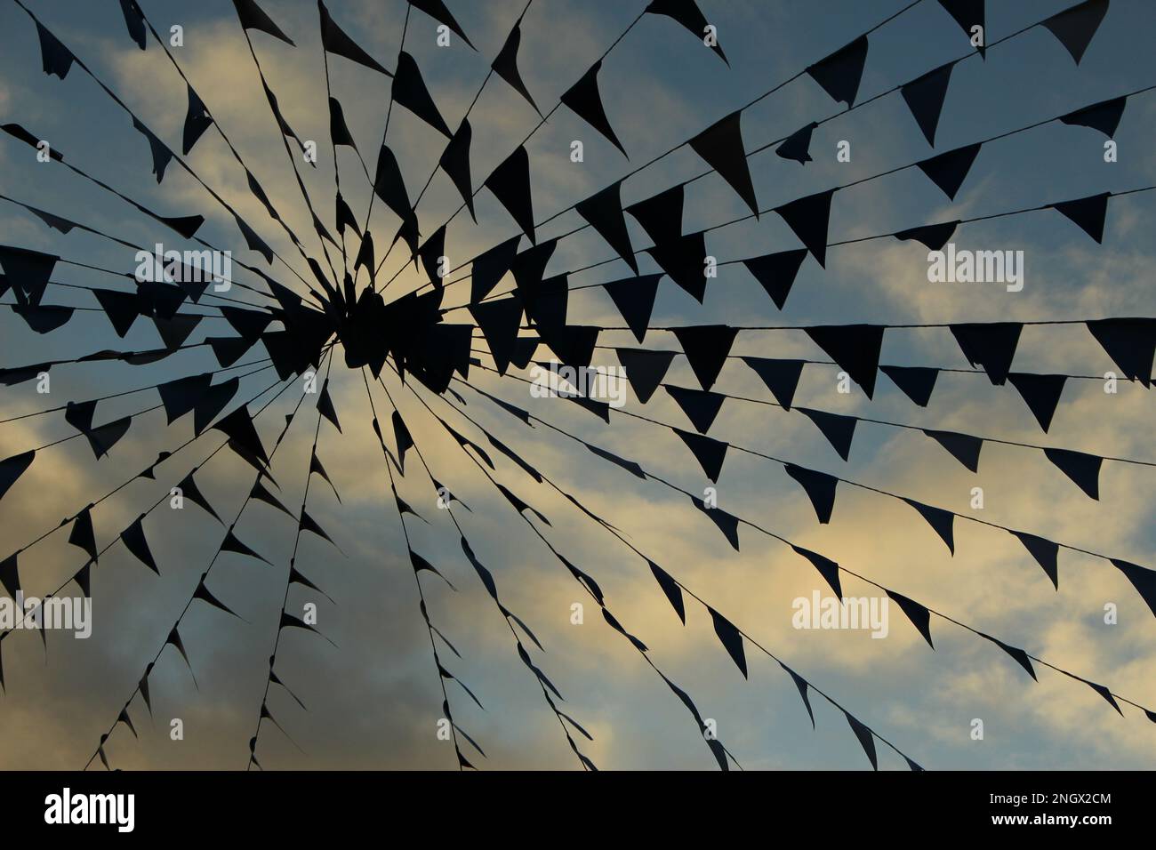 Silhouette of triangle flag banners radiating out in a circle against ...