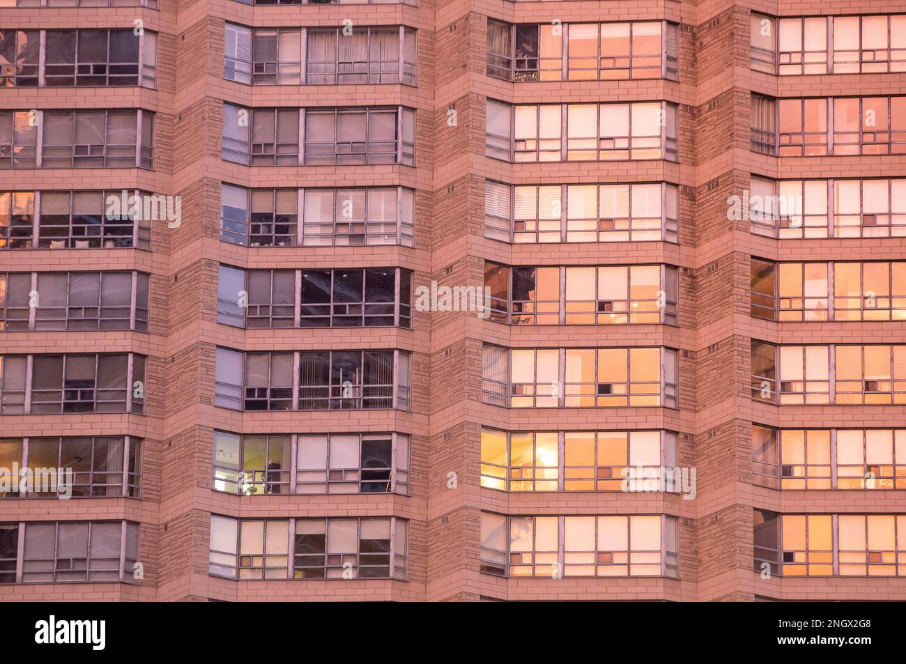 Urban geometry. Rows of large windows with various curtains, shutters ...