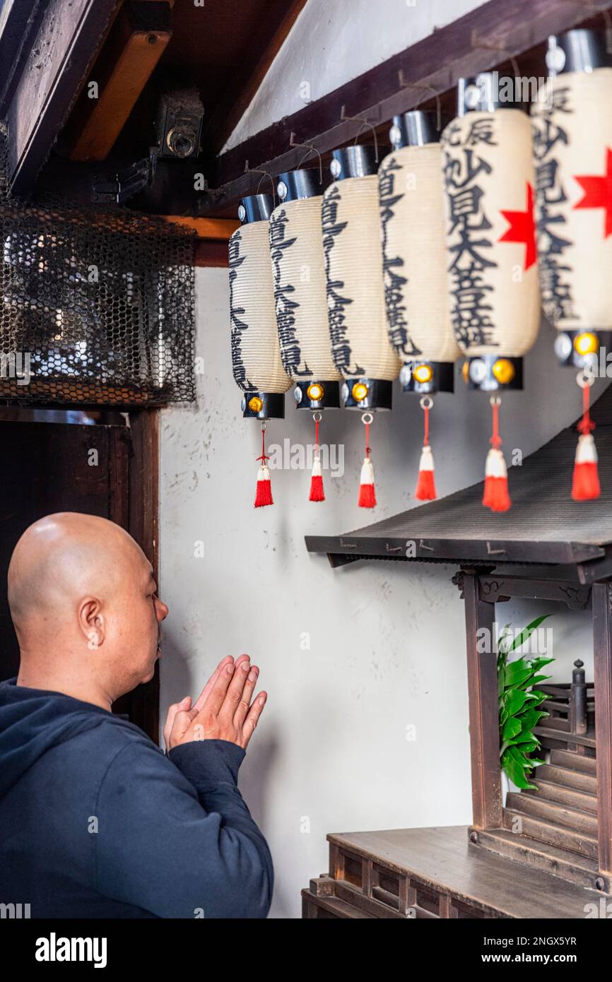 Kyoto Japan. man praying at Yasaka shrine Stock Photo - Alamy