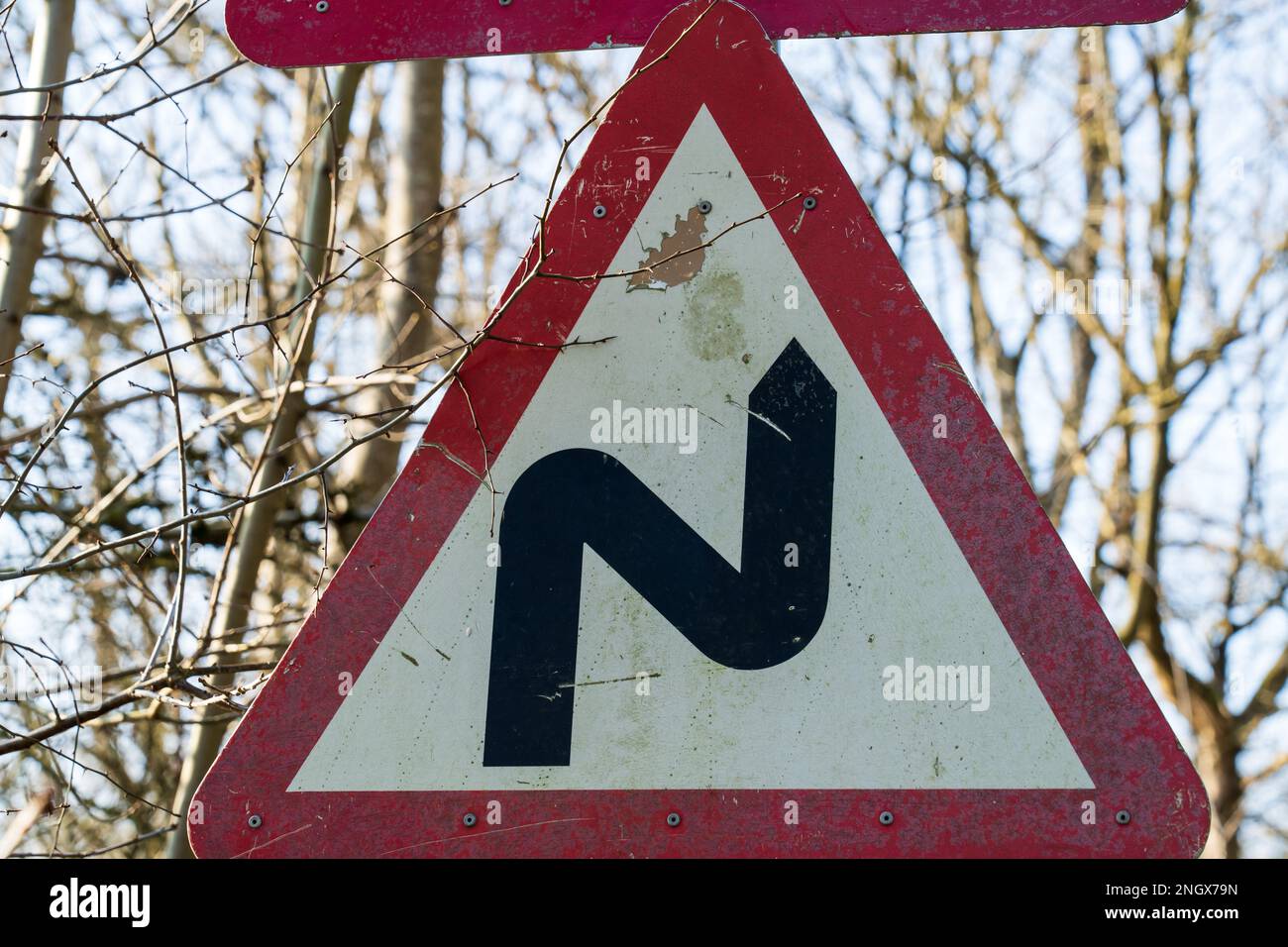 UK Traffic sign stating winding road with a read and white warning ...