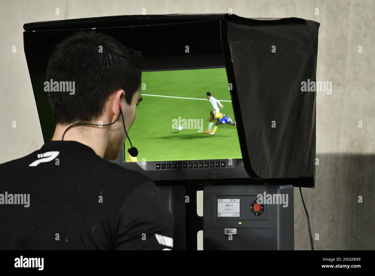 referee Brent Staessens watches a scene on the VAR video referee screen ...