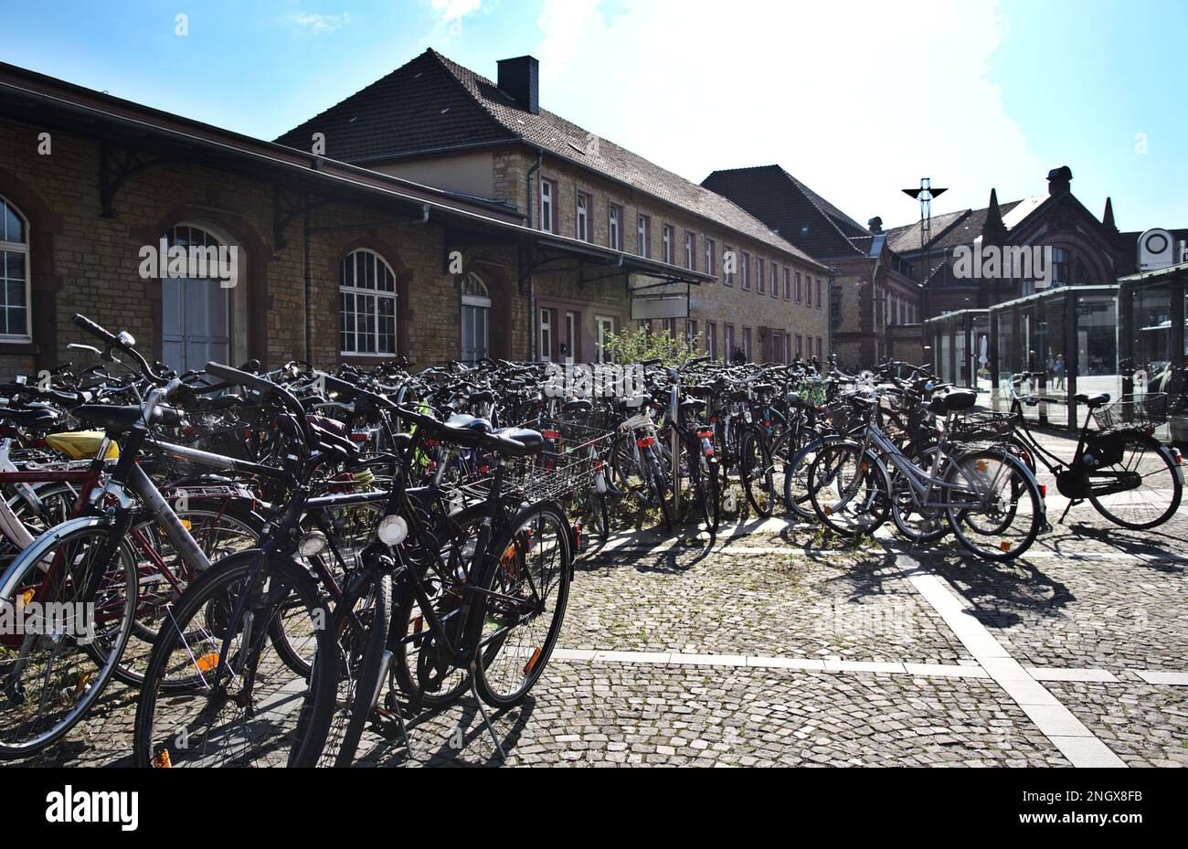 multiple bicycles parked by railway station building Stock Photo - Alamy