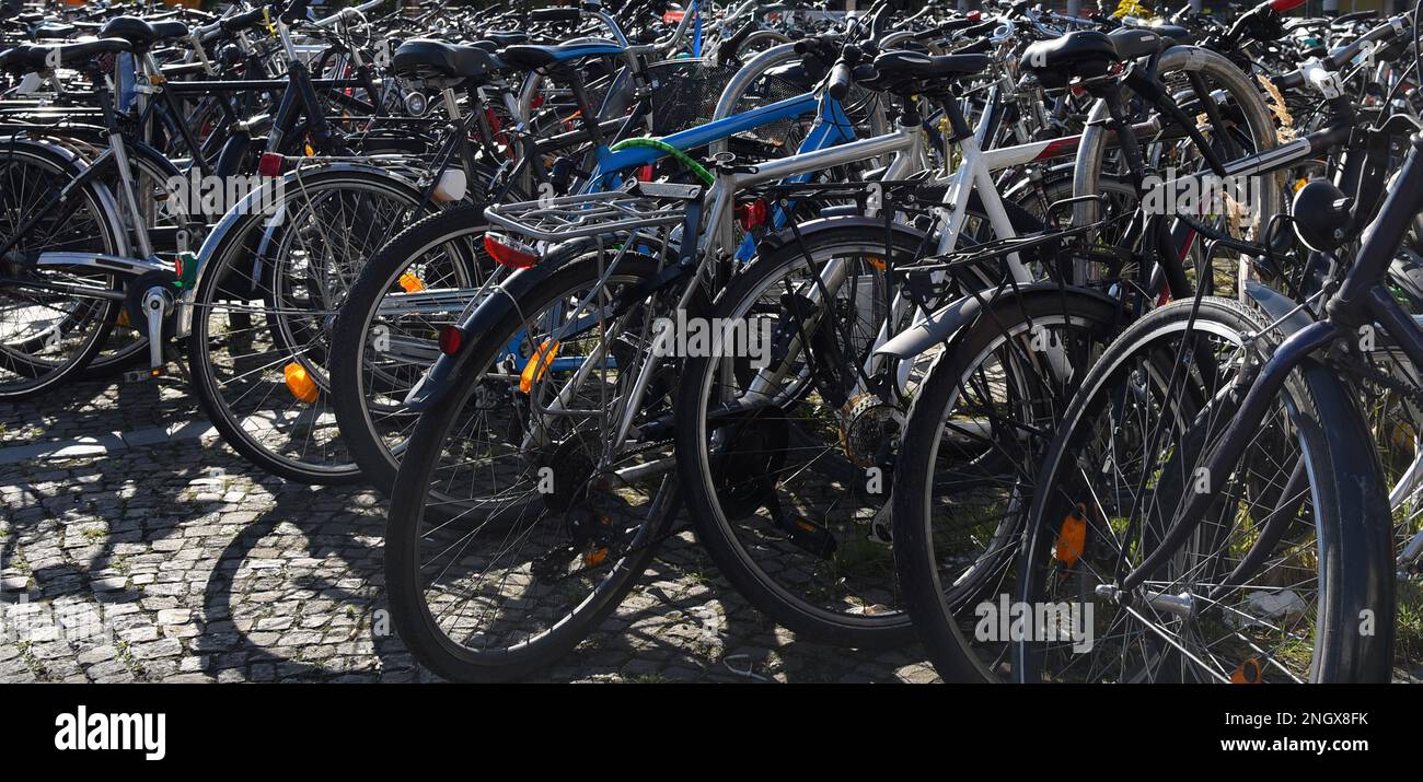 multiple bicycles parked by railway station building Stock Photo - Alamy