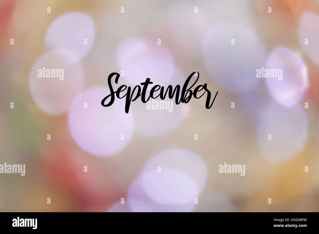 A blurred colorful background with the name "September" in English ...