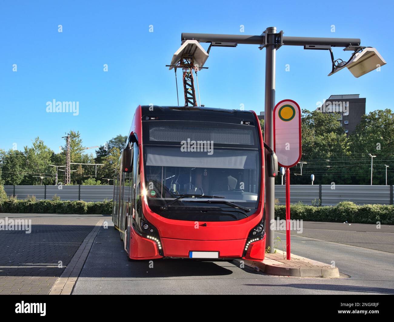 Electrical bus recharging at an overhead charging bus stop Stock Photo ... Electrical bus recharging at an overhead charging bus stop Stock Photo ...