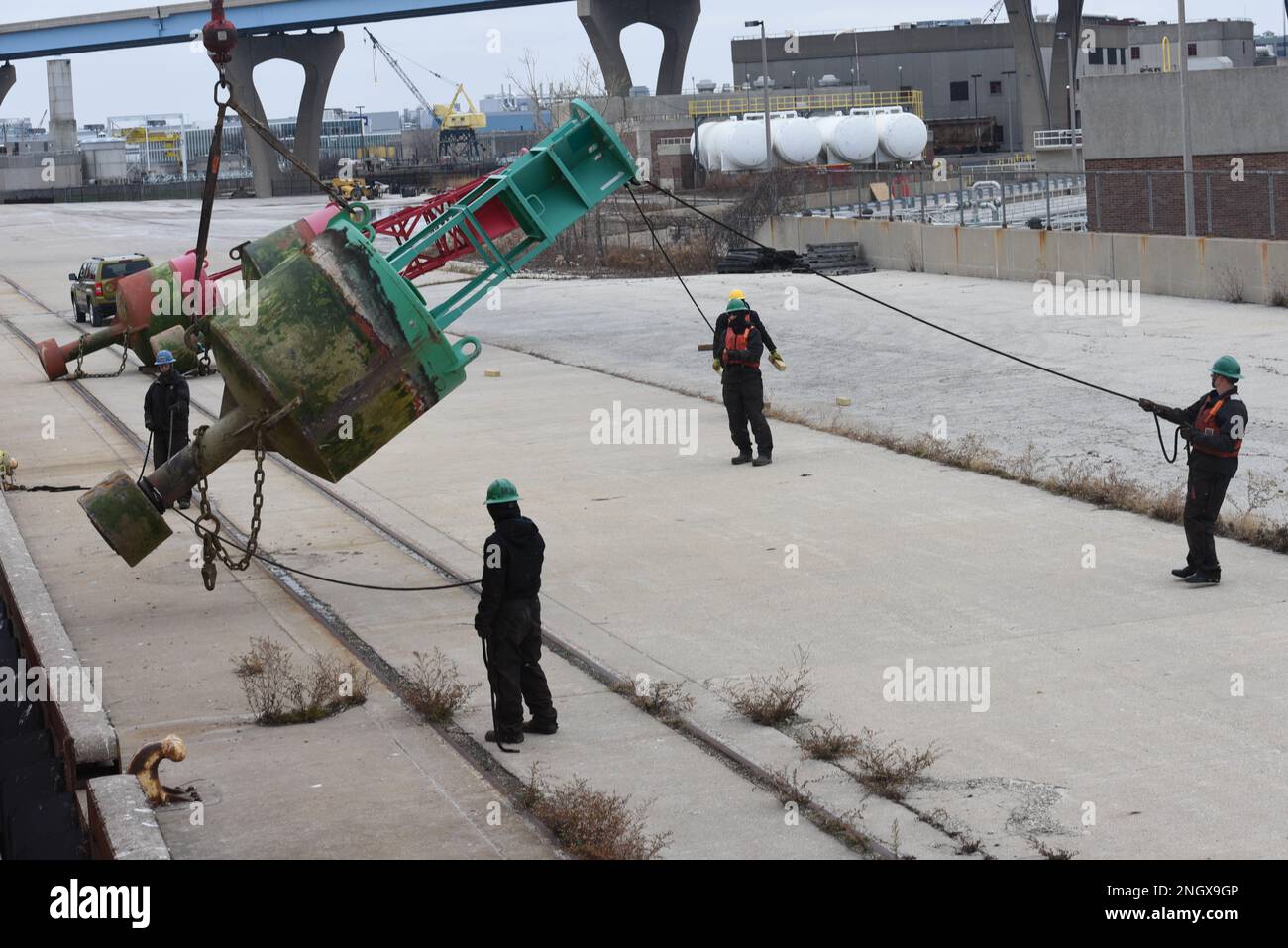 Crewmembers onboard USCGC Mackinaw (WLBB 30) tend lines as buoys are ...
