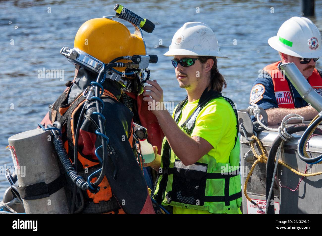 A government contract diver prepares to off-load fuel from a wrecked ...