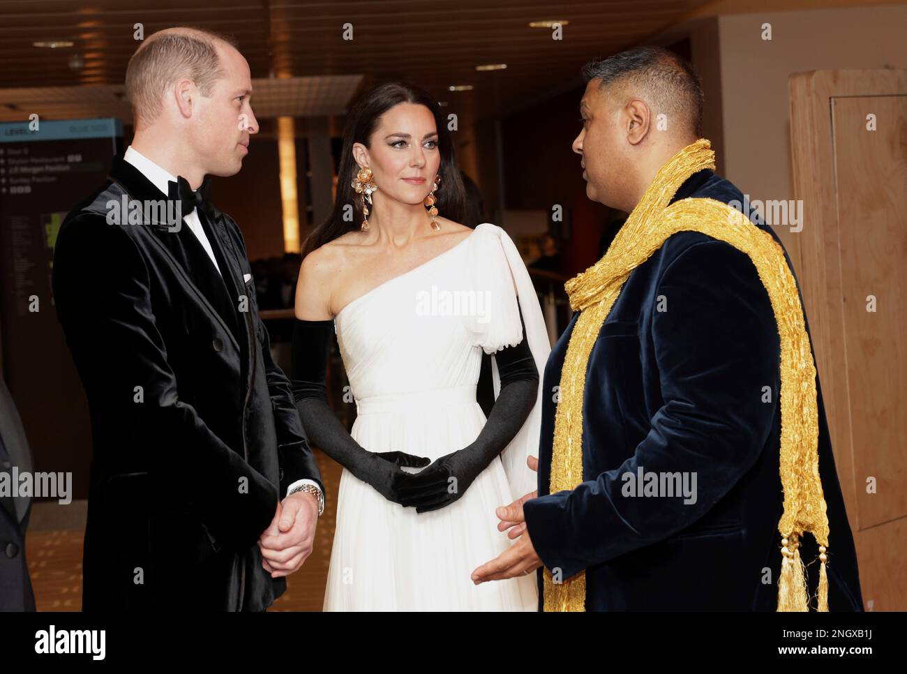 Britain's Prince William, left and Kate, the Princess of Wales speak to ...