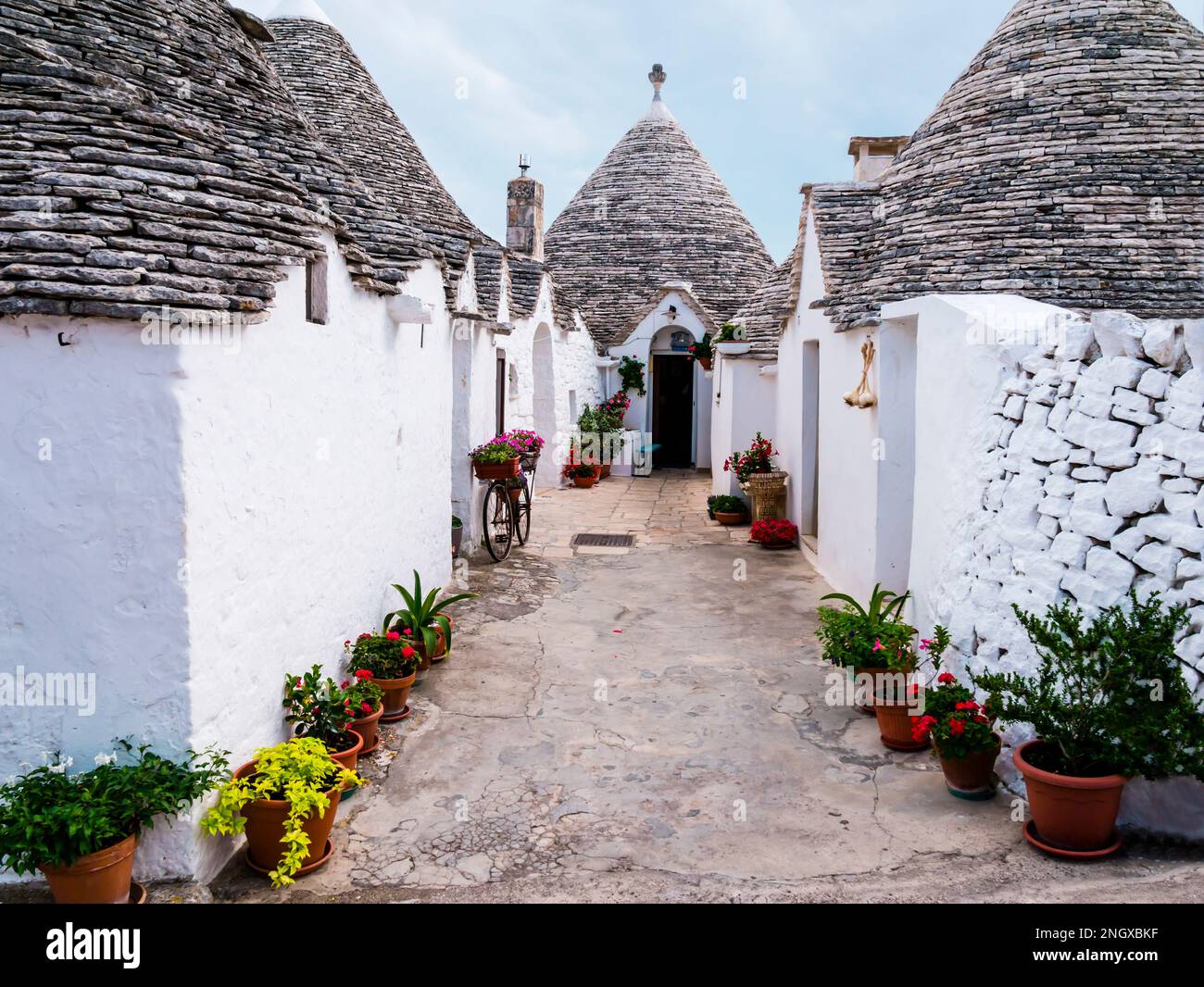 Typical alley of the village of Alberobello with traditional trulli ...