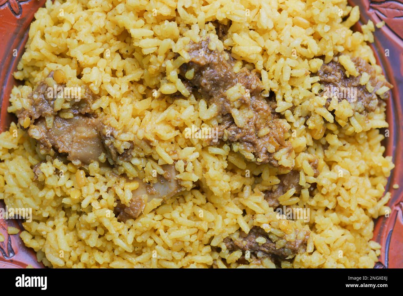 boiled yellow rice with meats on a plate Stock Photo - Alamy