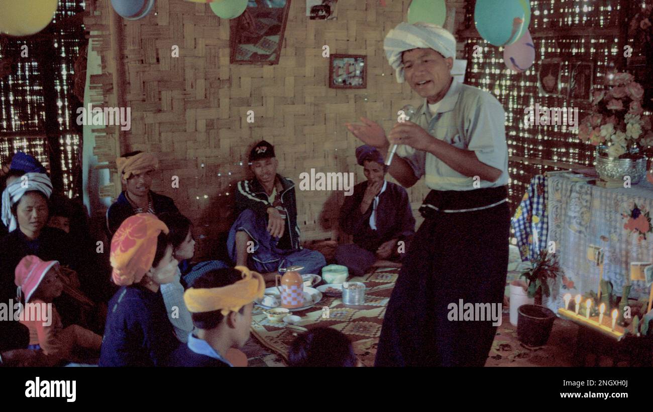 Guests at an indigenous Karen wedding listening to the presiding priest ...