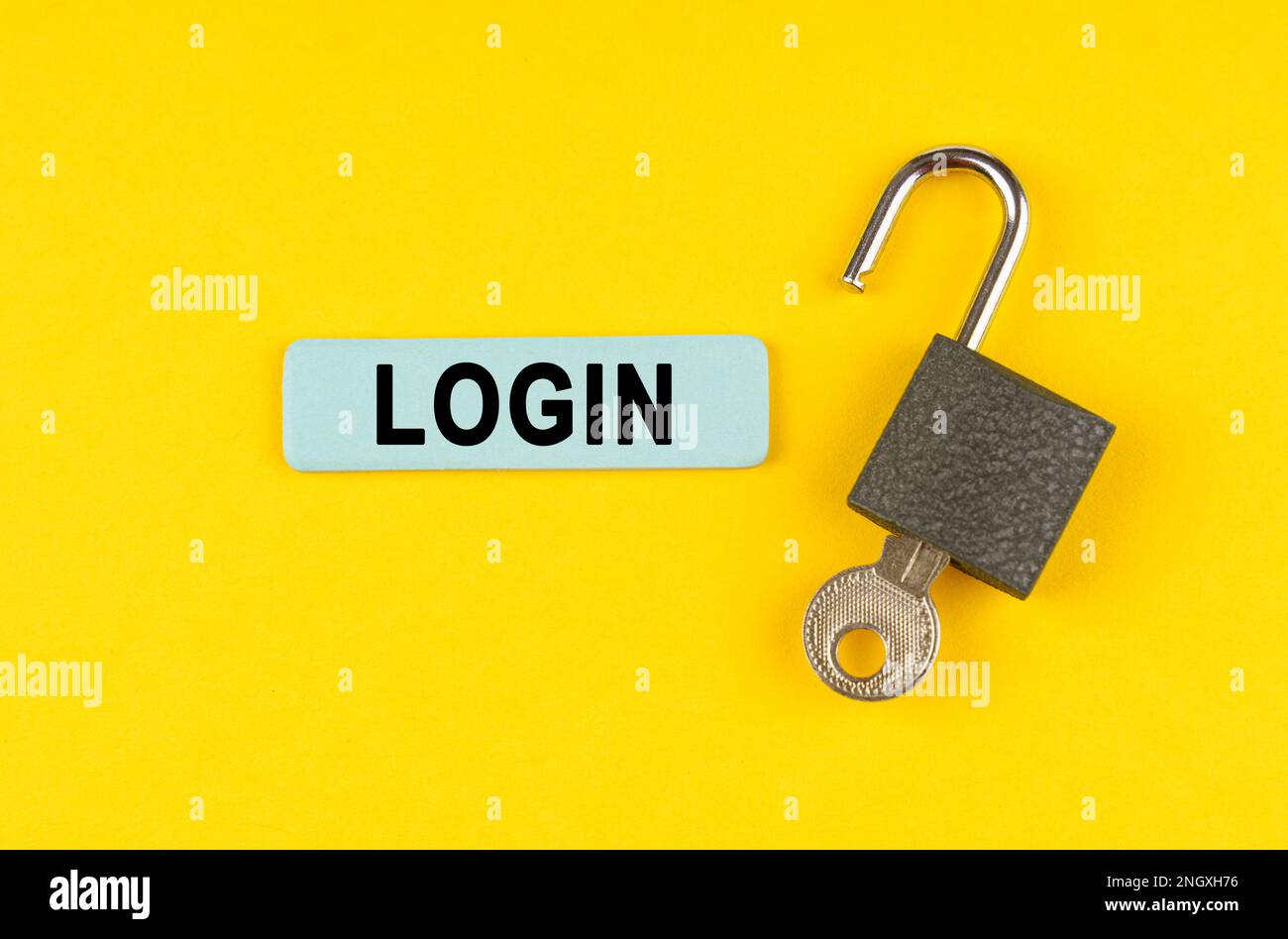 On the yellow surface lies an open lock with a key, next to it is a ...