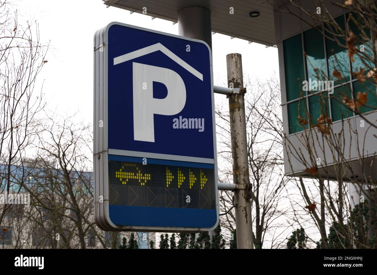 The building has a parking road sign with a traffic indicator for ...