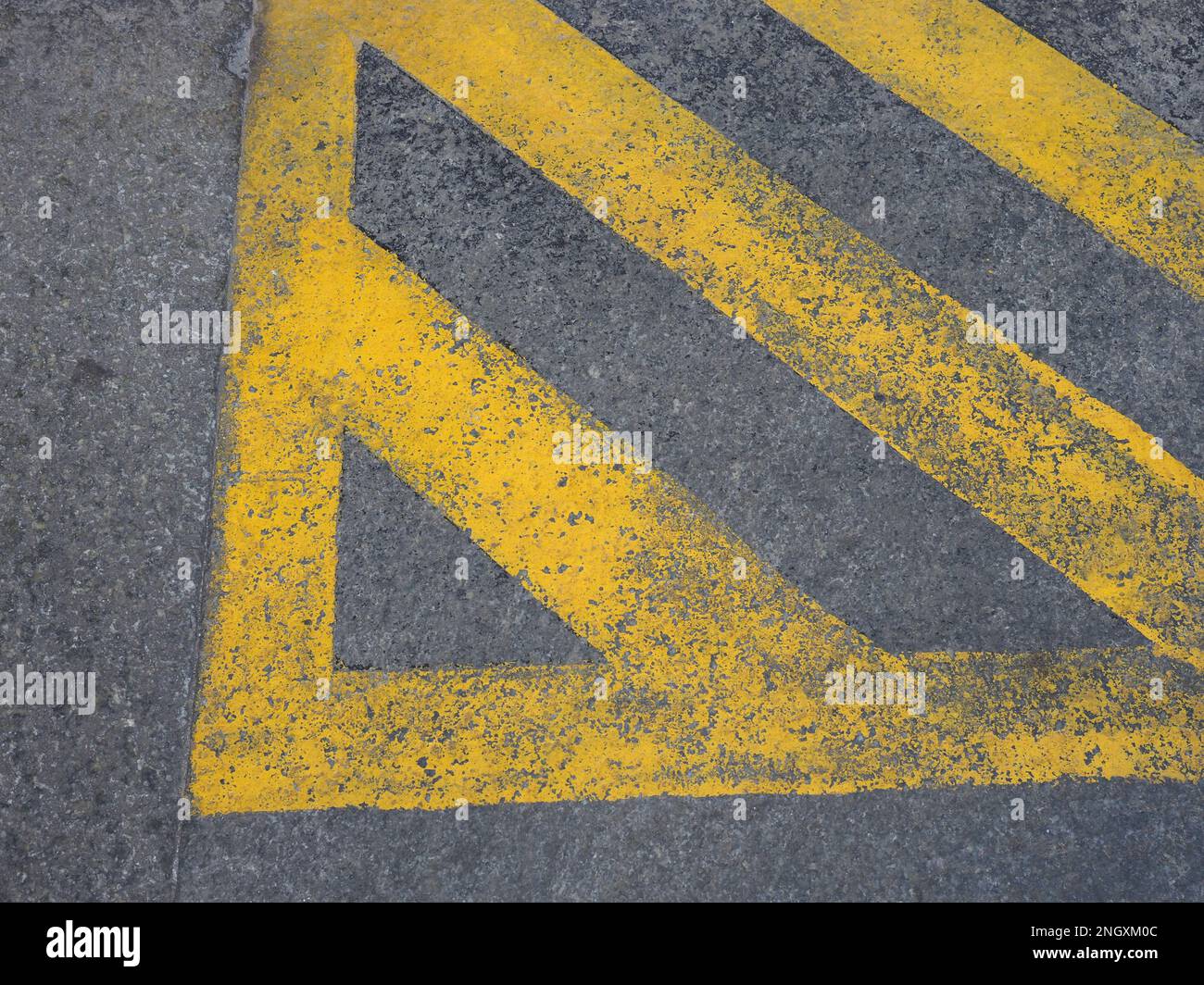 yellow lines warning sign painted on tarmac Stock Photo - Alamy
