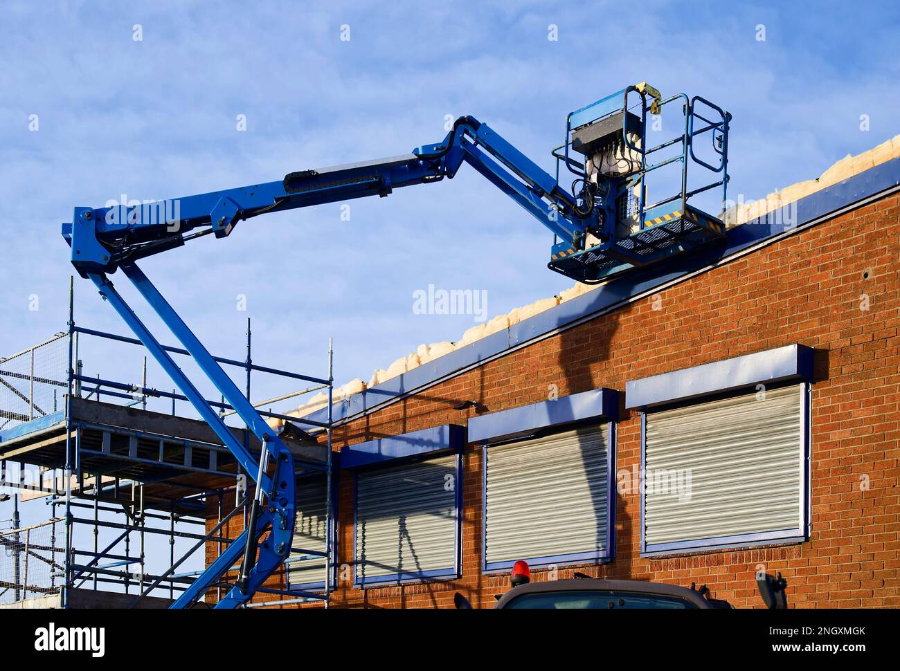 Access platform equipment powered high in sky at construction building ...